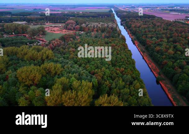 Vibrant Dutch autumn scene. Trees display vibrant fall colors alongside ...