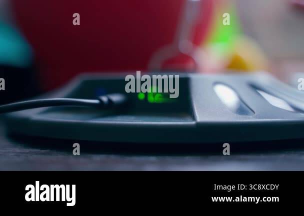Green light flashing in the background, charging indication on an ...