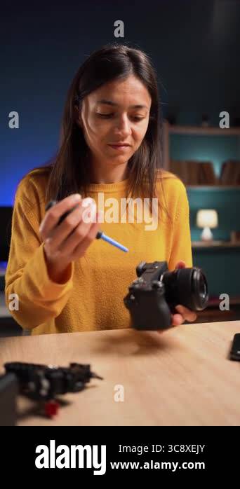Woman cleaning camera blowing dust and dirt with blower. Concept of ...