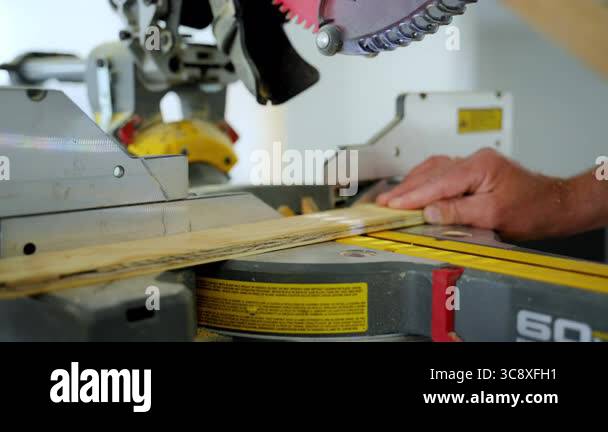 Electrical saw, the electric power carpentry tools. Man is cutting wood ...
