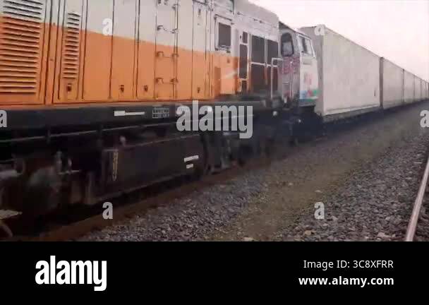Train carrying container boxes passes Stock Video Footage - Alamy