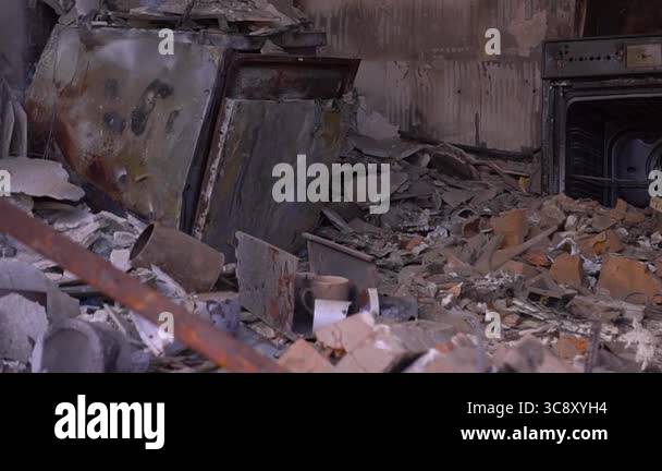 A room filled with debris and a stove in the background signifies a ...