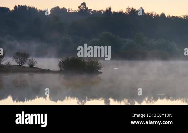 Foggy morning landscape. Fog over autumn lake water. Povoa e meadas dam ...