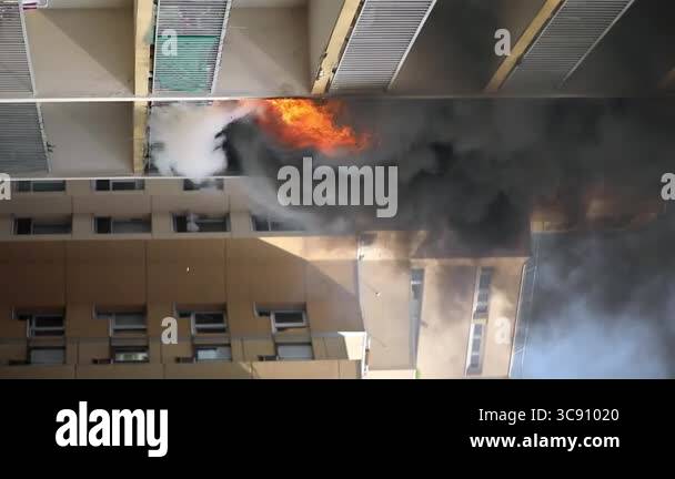 Residential building on fire, flames and smoke breaking out from the ...