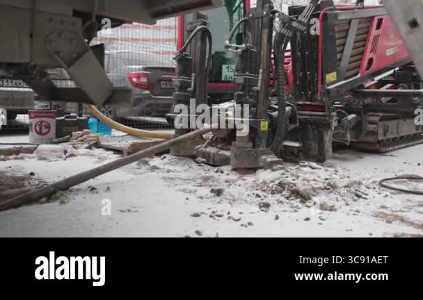 Heavy industrial machinery highlights protruding metal rod amid red ...