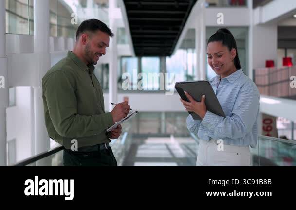 two managers discussing business project walking together in office and ...