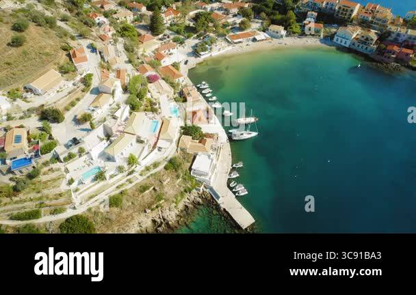 Colorful coastal village Asos with yachts and beach in a bay on ...