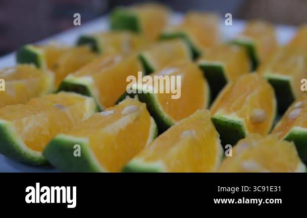 Sliced orange slices on a plate. Juicy orange. Vietnamese Green ...