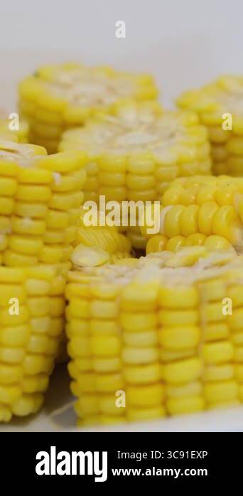 Boiling corn in pot with bubbling water during cooking process ...