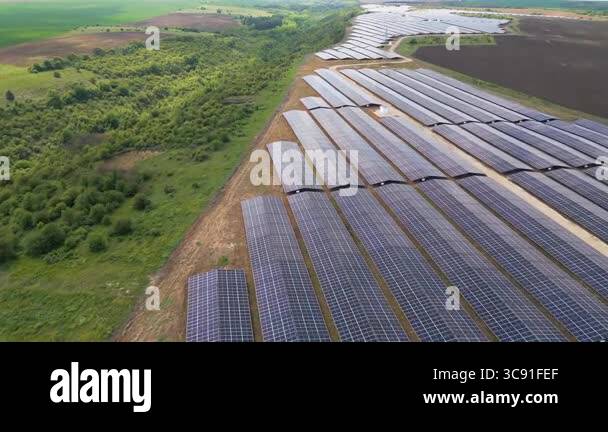 Aerial view of a large solar power farm with rows of photovoltaic ...