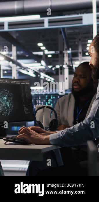 Vertical video Lead data center engineer oversees team integrating AI automation tools during ...