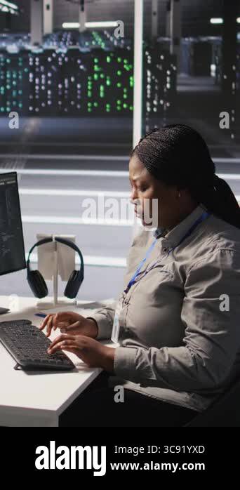 Vertical video Data center system administrator using PC to monitor neural network AI ...