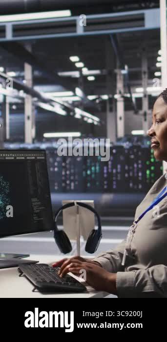 Vertical video Data center programmer coding on PC, doing software ...