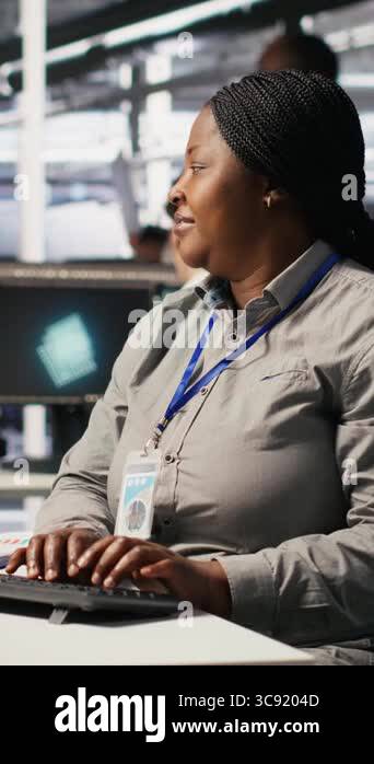 Vertical video Data center computer scientist using PC to monitor artificial intelligence ...