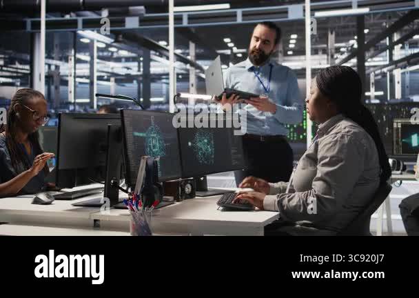 Annoyed data center employee making rude hand gesture toward colleague ...