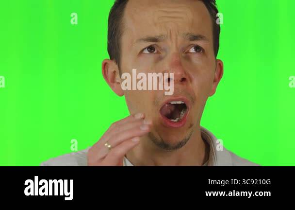 A young male appears visibly tired, yawning and showing sleepy ...