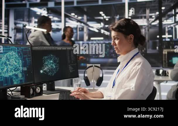 Data center software developer using PC to monitor neural network AI ...