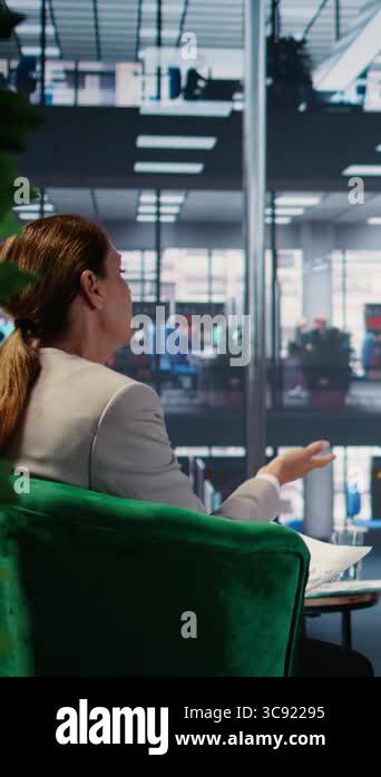 Vertical Video Business professionals in an office meeting for research ...