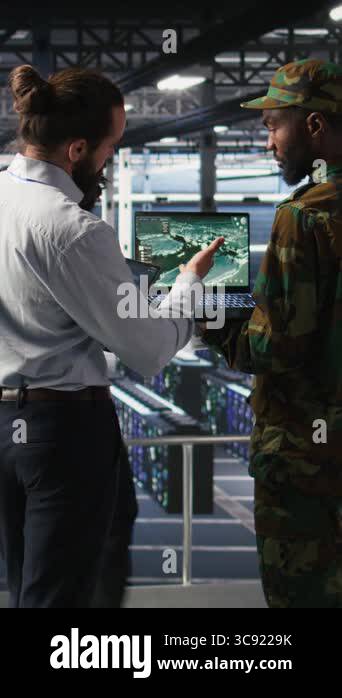 Vertical video Military experts in data center reviewing drone ...