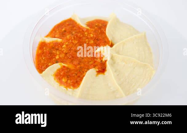 A top view of hummus sauce rotating on a white background. Showing the ...