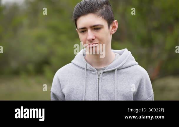 Sad sorrowful teenage boy grimacing in grief and sadness. Melancholy ...