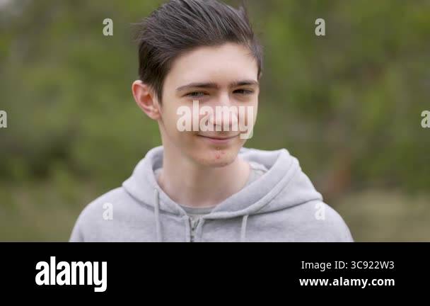 Portrait of sly teenage boy outdoors. Clever young man with mischievous ...