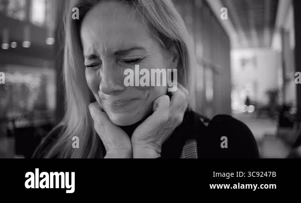 Black and white image of woman crying with hands on face, eyes shut ...