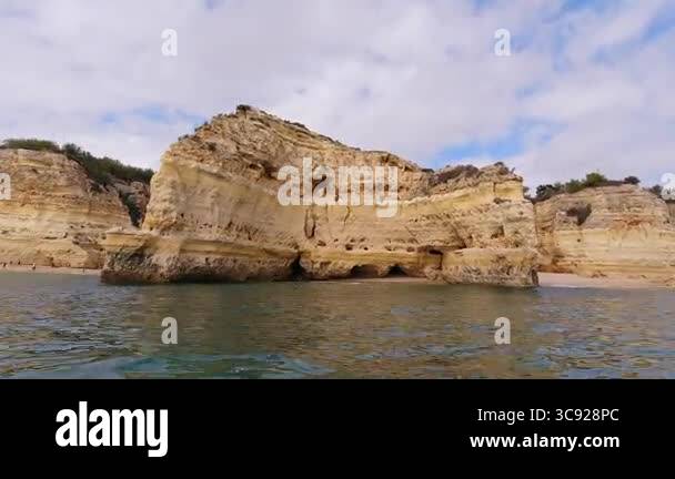 Breathtaking view from boat of dramatic golden limestone cliffs rising ...
