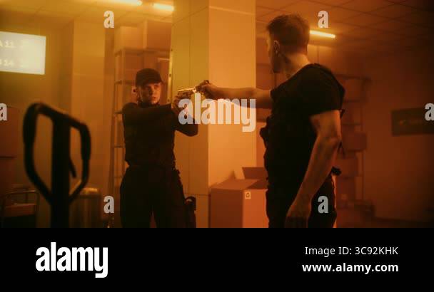 Tense Standoff in Action Movie: Man and Woman in Tactical Gear Pointing ...