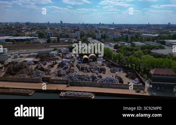 Aerial view of a metal scrap yard, showing workers sorting and managing ...