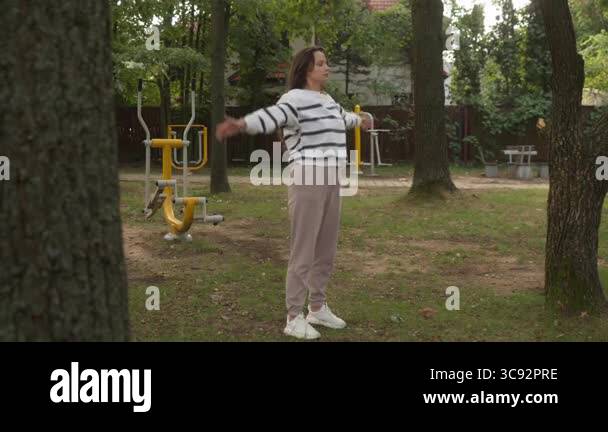Active woman preparing for her fitness routine with arm rotation ...