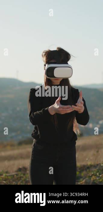 Vertical Video of Girl in vr headset playing adventure game, youth ...