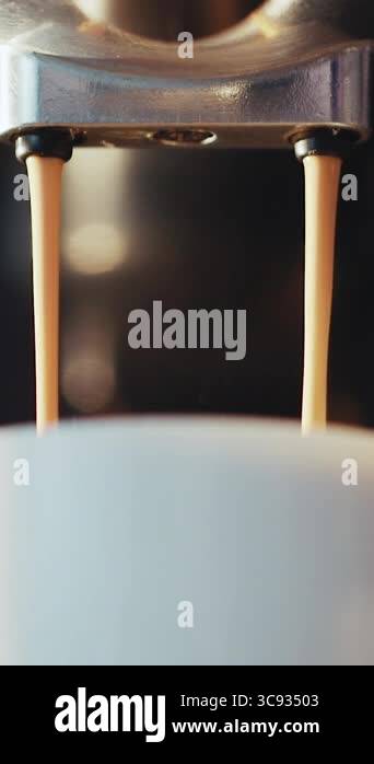 Vertical Format Video of Coffee machine making espresso in cup covered ...