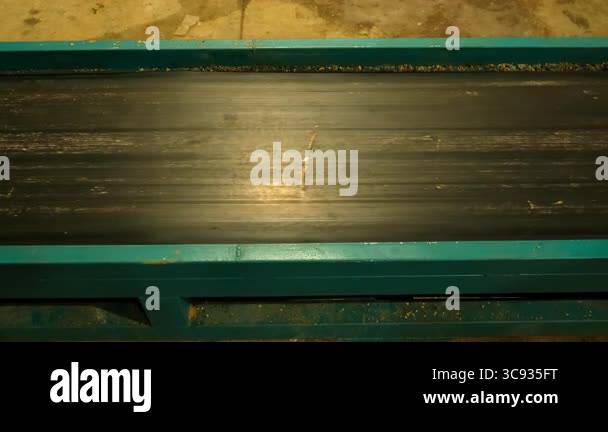 Empty conveyor belt moving through factory on woodwork manufacturing ...