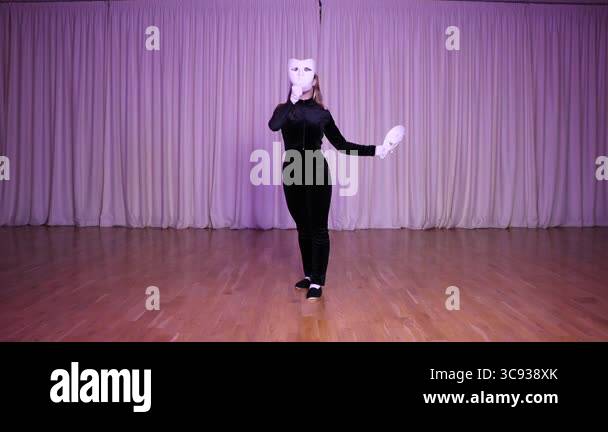 Pantomime scene, an actress demonstrates her work with two white masks ...