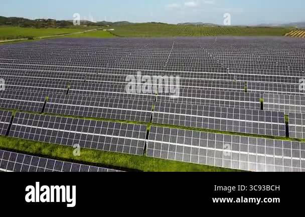 Rows of solar panels stretch across a vast field, generating clean ...
