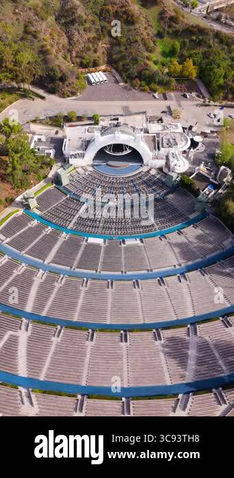 Vertical drone shot of a large outdoor amphitheater nestled in the ...