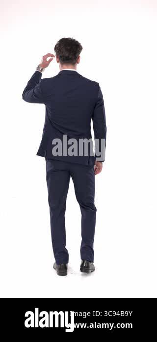 back view of elegant young man scratching head and being confused while ...