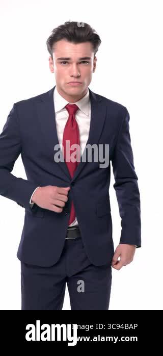 arrogant elegant man in navy blue suit holding elbow on knee, looking ...