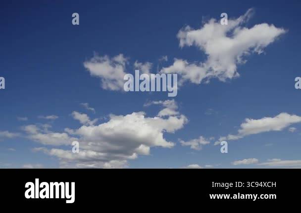 Captivating motion of clouds moving swiftly across a vivid blue sky in ...