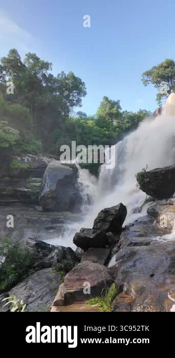 The nature of the waterfall in the forest that flows strongly during ...