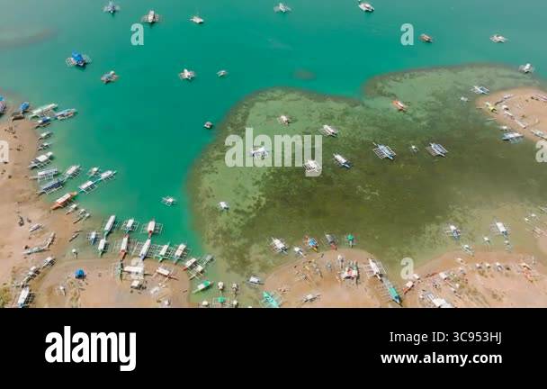 Top view of tourist boats floating over the turquoise sea water. Coron ...