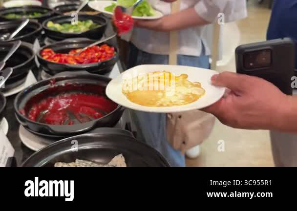 pour ketchup and chili sauce over egg. buffet male hand cooking ...