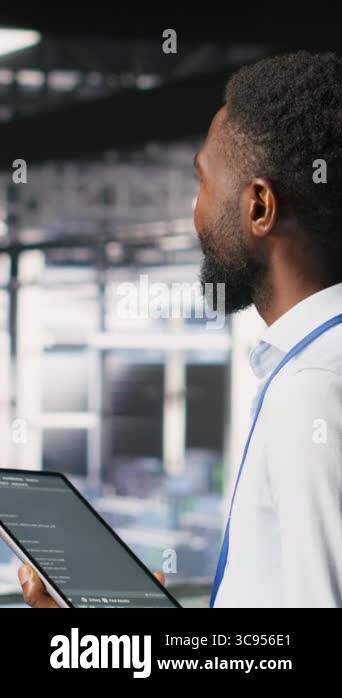 Vertical video Data center programmer checking lines of code and colleague reviewing AI LLM ...