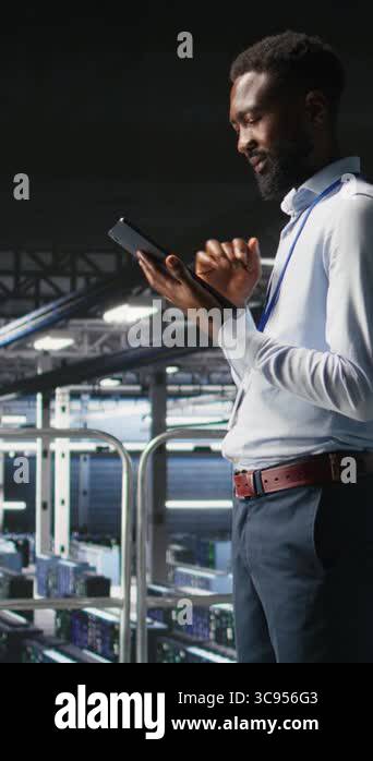 Vertical video Software developers on data center industrial platform analyzing performance ...