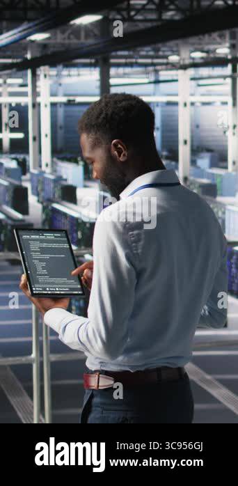 Vertical video Data center programmers on industrial platform checking ...