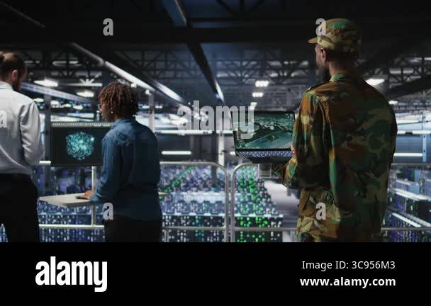 Military technician reviewing tactical dashboard on laptop screen ...