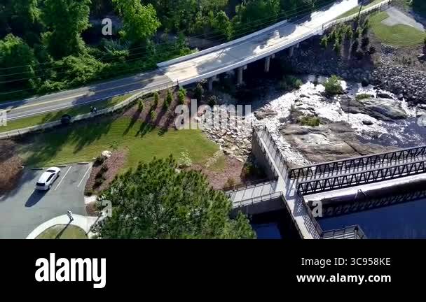 Aerial view of a mill pond dam in South Carolina with pollen floating ...