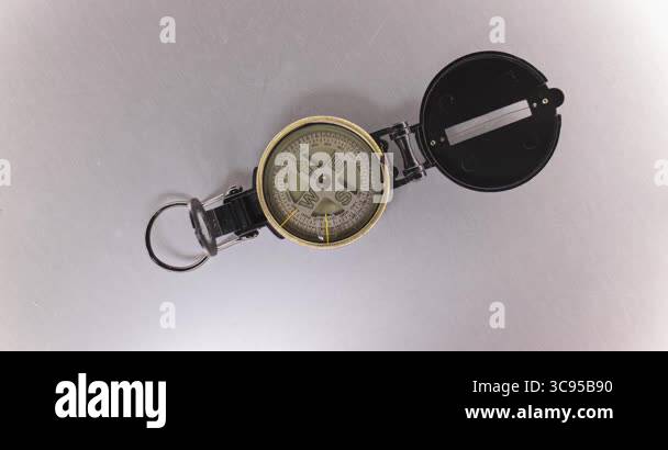 Magnetic compass spinning around close up, swinging poles Stock Video ...