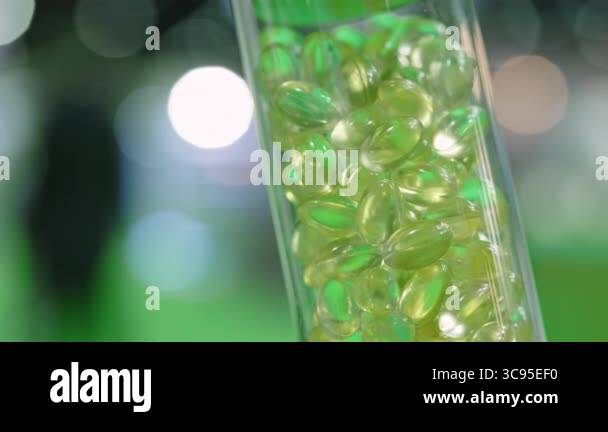Close-up shot of translucent softgel capsules stored in a clear tube ...
